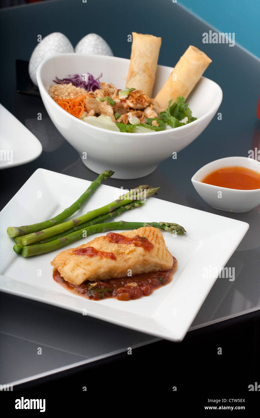 Freshly prepared Thai style sea bass fish dinner with asparagus and ...