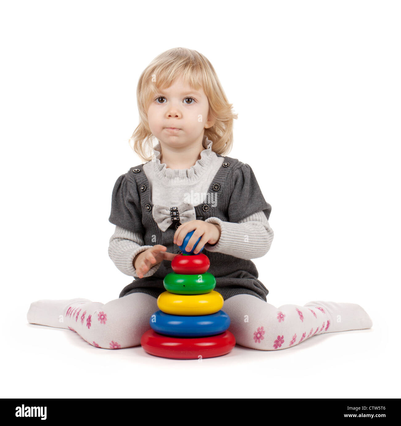 Baby girl with a toy pyramid. Isolated on white background Stock Photo ...