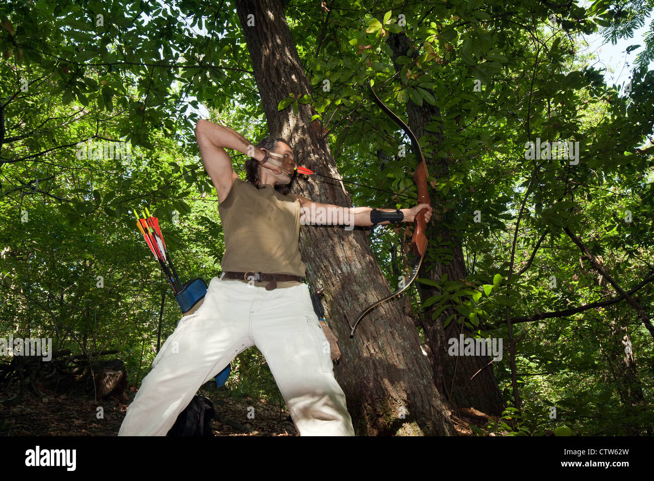 archer with recurve Bow aiming in the forest Stock Photo - Alamy