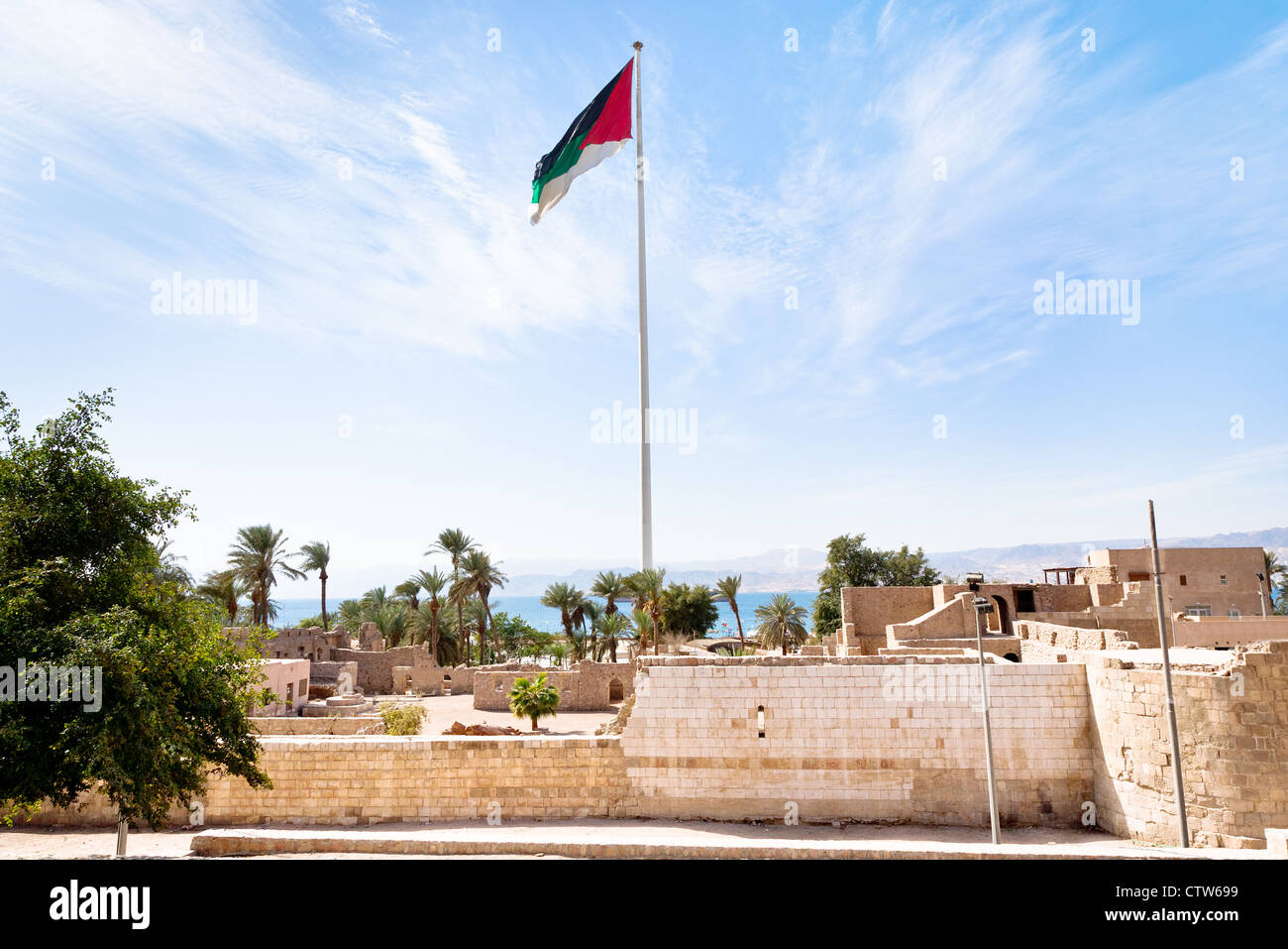 The Aqaba Flagpole under ruins of medieval Mamluks Aqaba fort Stock ...