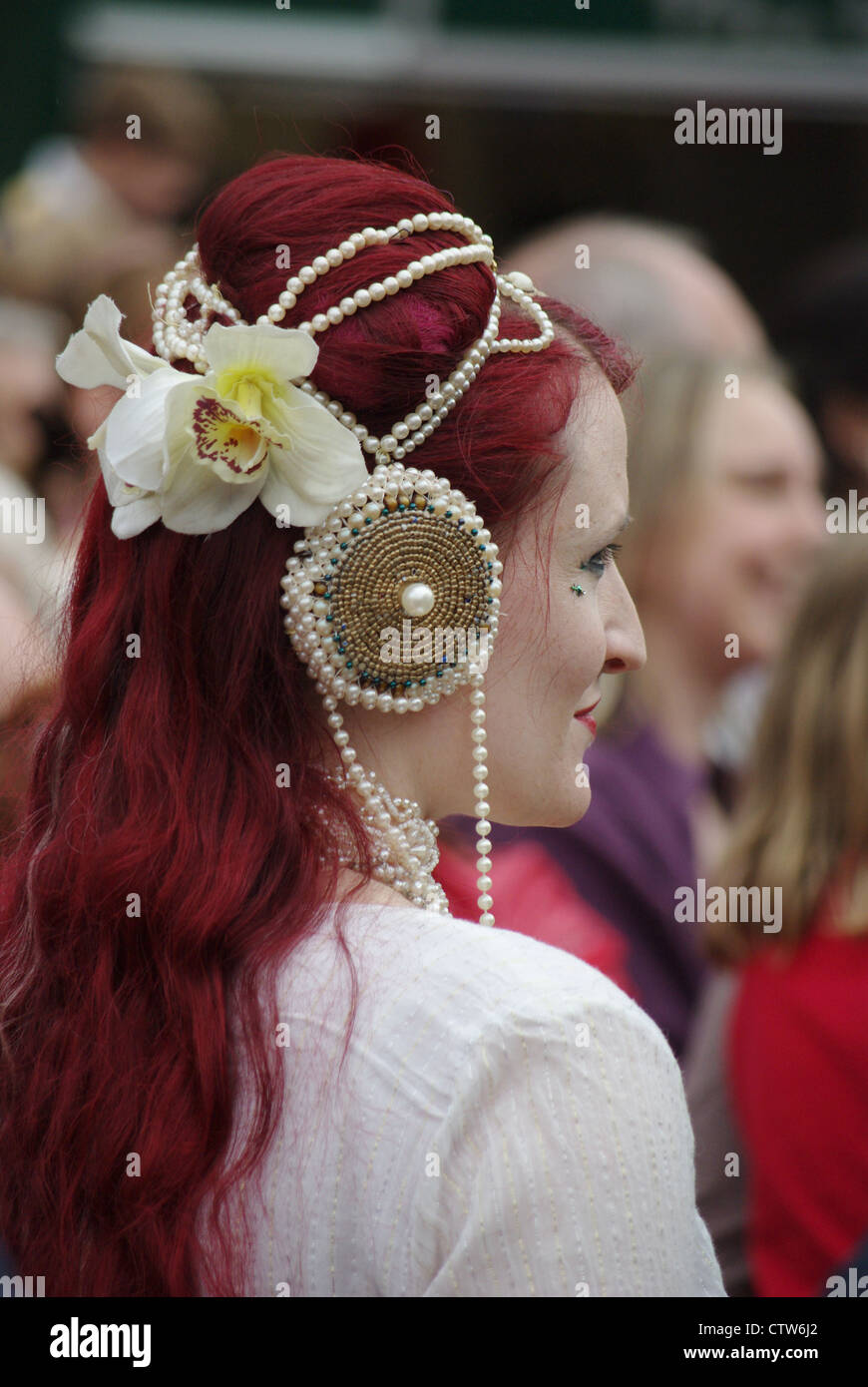 Side profile of a red-haired woman belly dancer wearing an Eastern ...