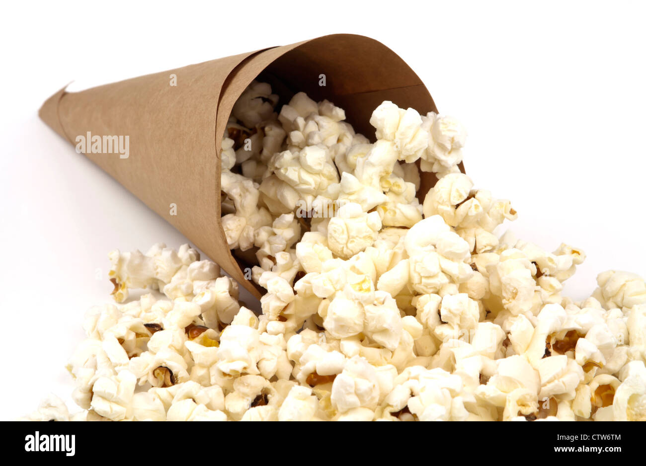 White fluffy tasty popcorn spilling from a brown paper cone isolated on ...