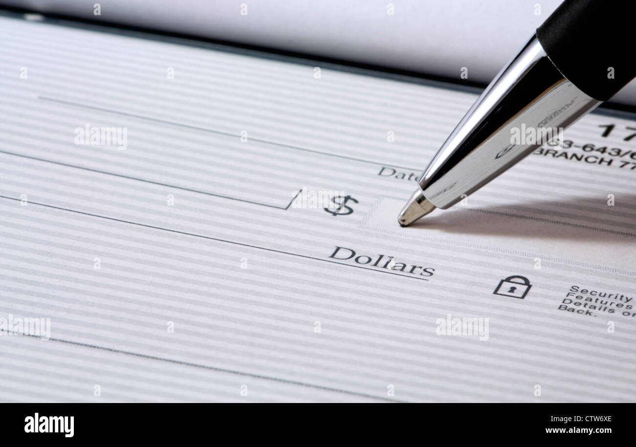 Close up of pen filling out a personal bank check with copy space Stock ...