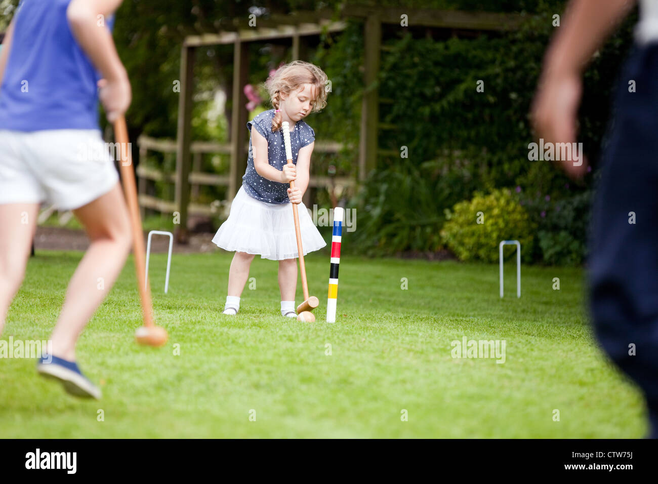 Young children playing croquet game outdoors in the garden, UK Stock ...
