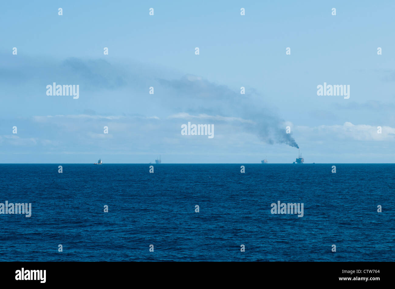 oil rigs in offshore area.... smoke going to atmosphere Stock Photo - Alamy