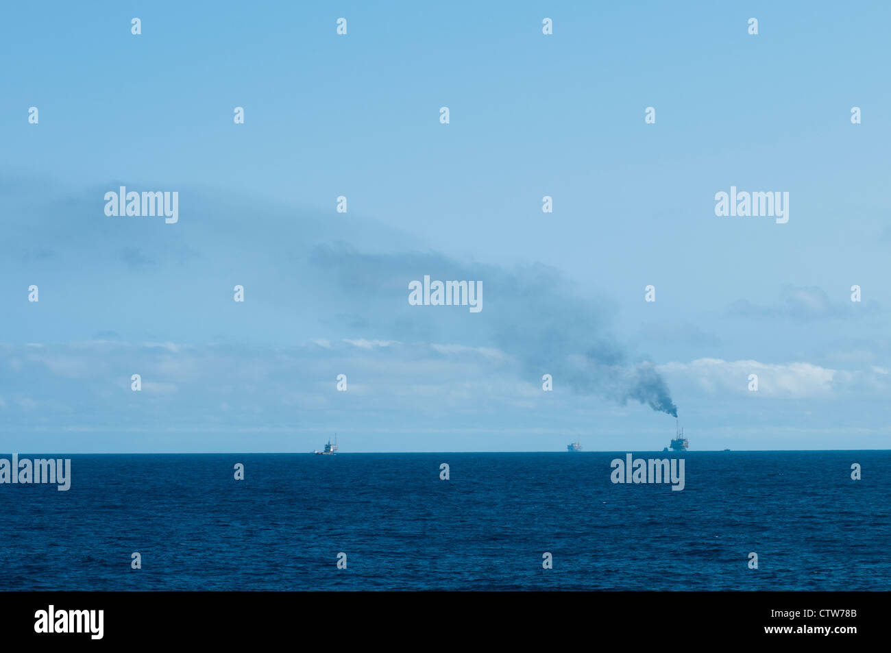 oil rigs in offshore area.... smoke going to atmosphere Stock Photo - Alamy