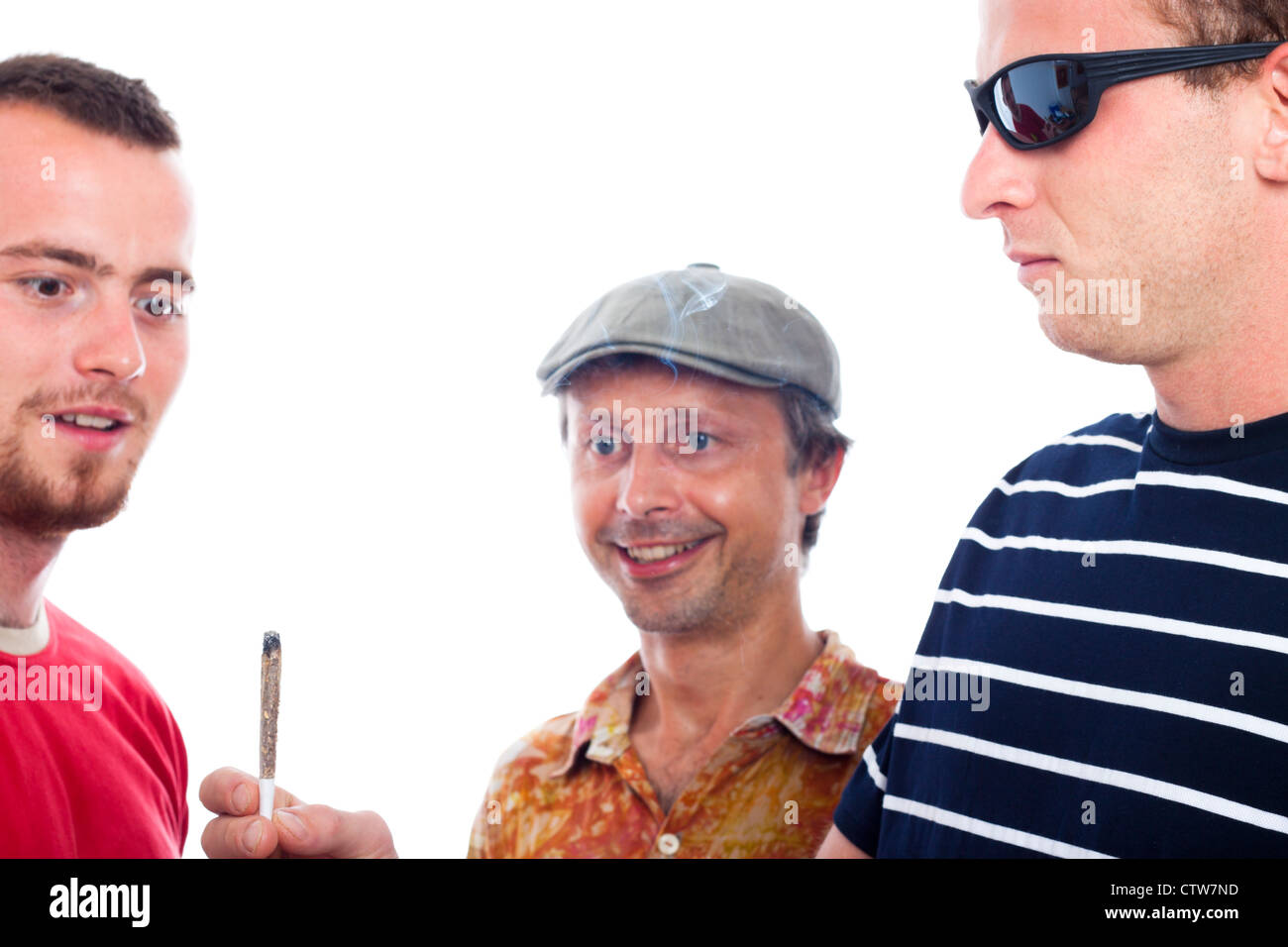 Three young excited guys sharing hashish joint, isolated on white ...