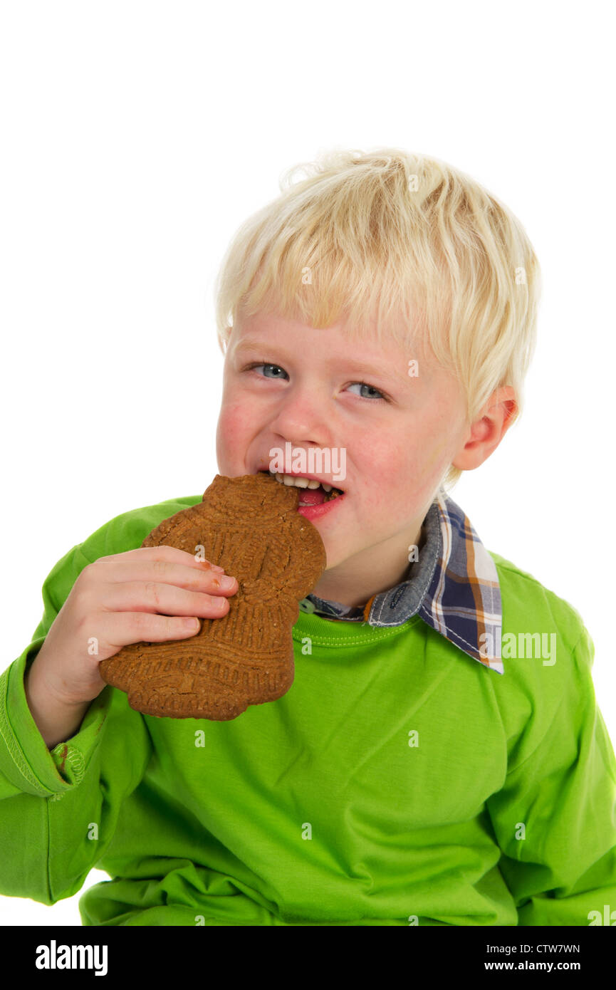 Little child is eating Dutch chocolate Sinterklaas speculaas puppet ...