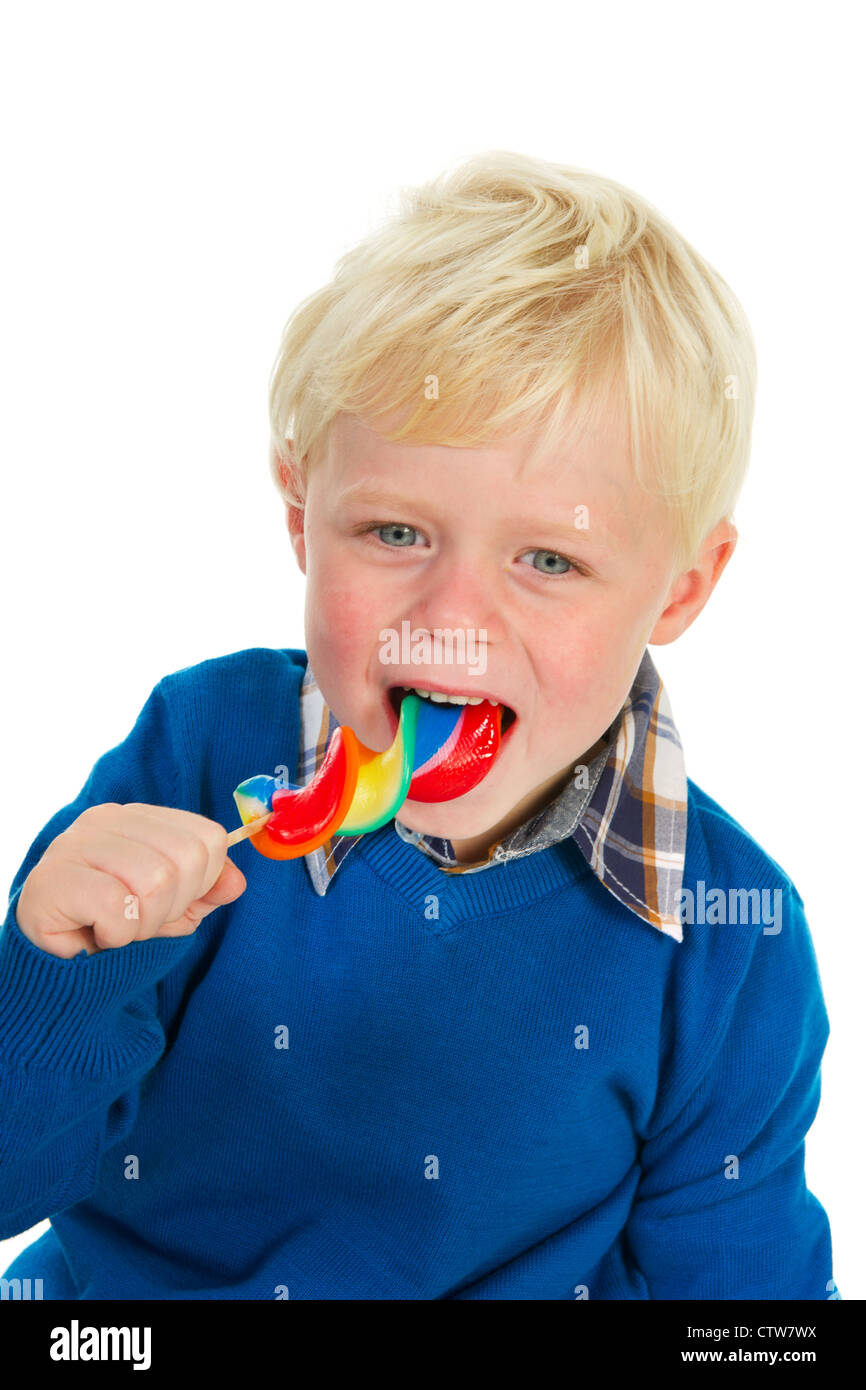 Portrait of a blond toddler eating a colorful lolly Stock Photo - Alamy