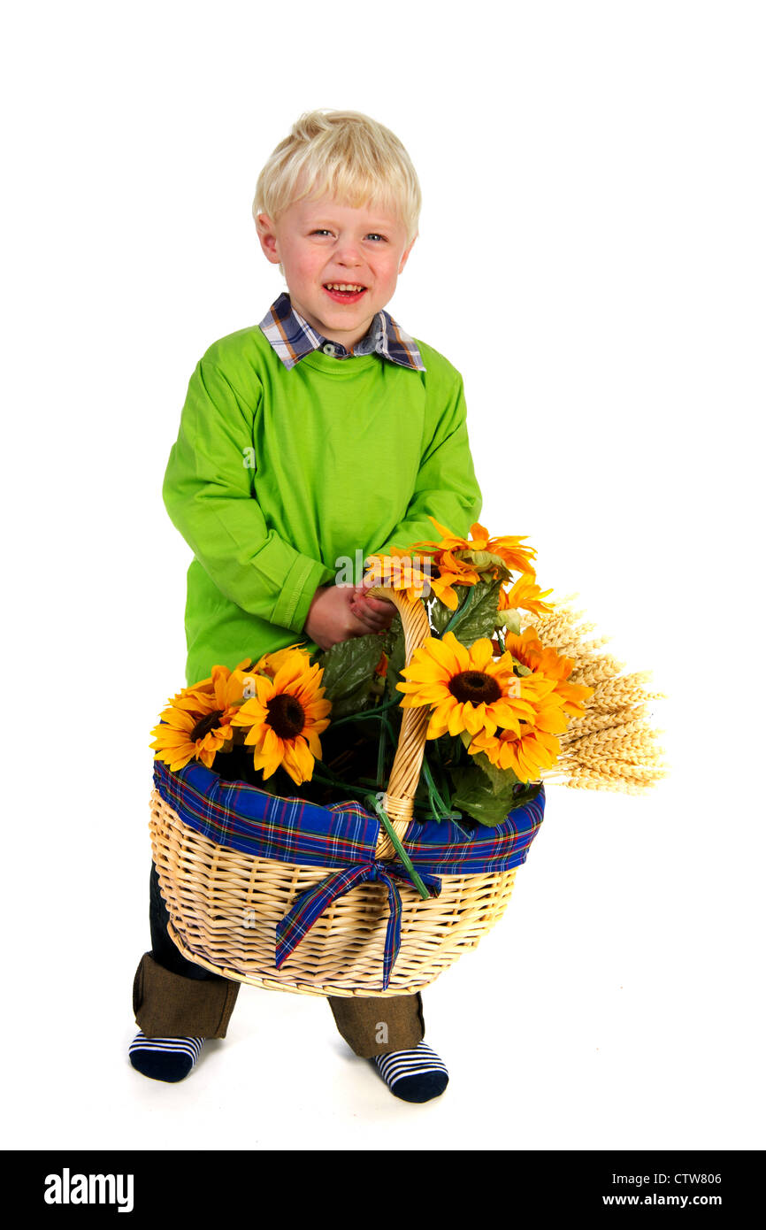 Portrait of a little blond boy carrying a flower basket Stock Photo - Alamy