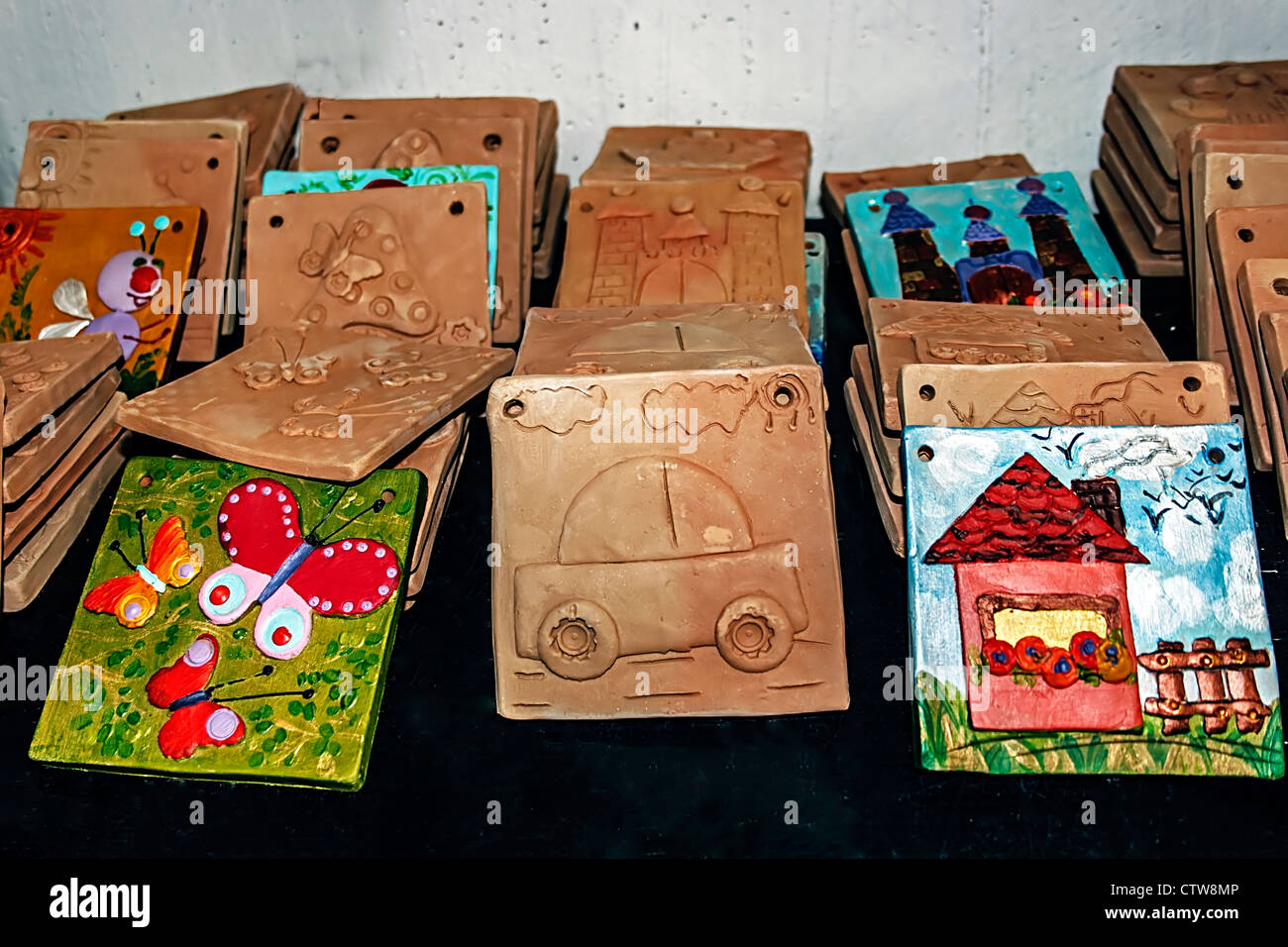 Different types of clay, with relief designs, ready to be colored by ...
