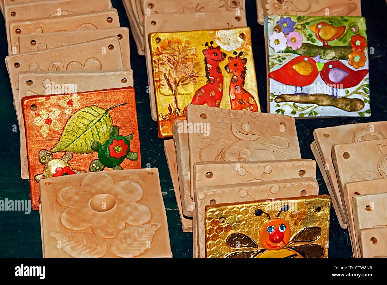 Different types of clay, with relief designs, ready to be colored by ...