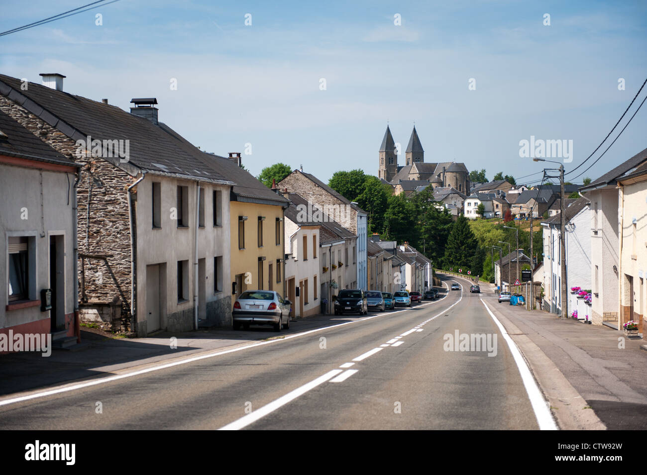 Main street in village Habay with cars and church Stock Photo - Alamy
