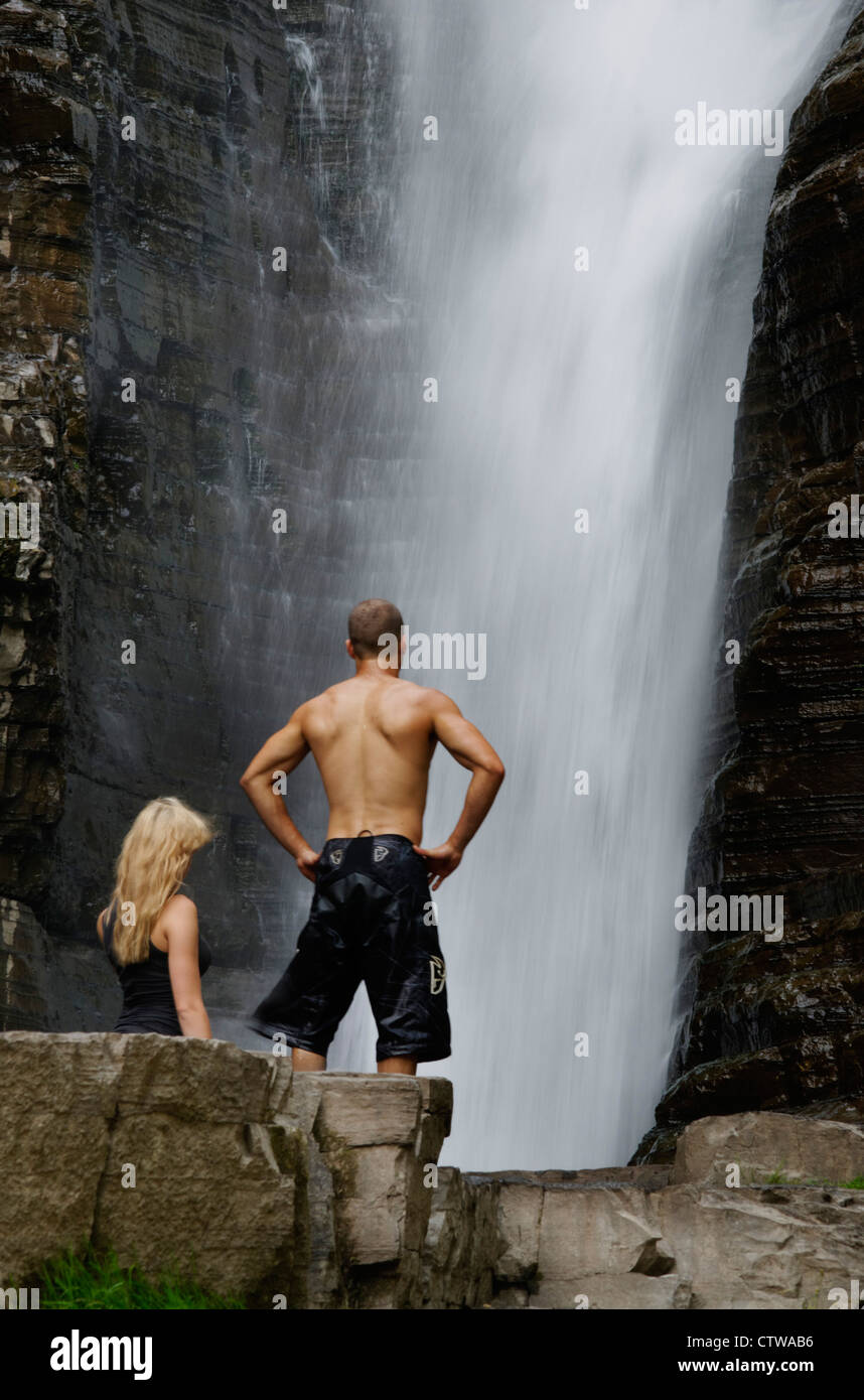 A young couple getting ready to jump into a waterfall Stock Photo - Alamy