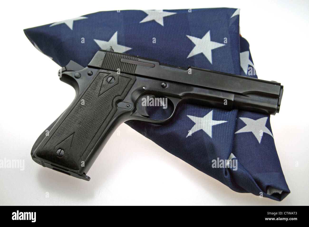 A nine millimeter semiautomatic pistol on a folded American flag Stock ...