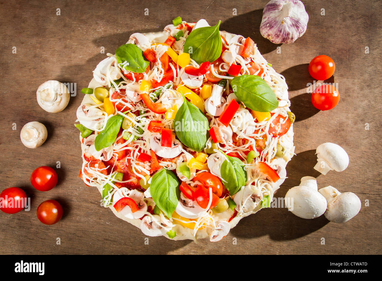 Close-up of the pizza before baking Stock Photo - Alamy