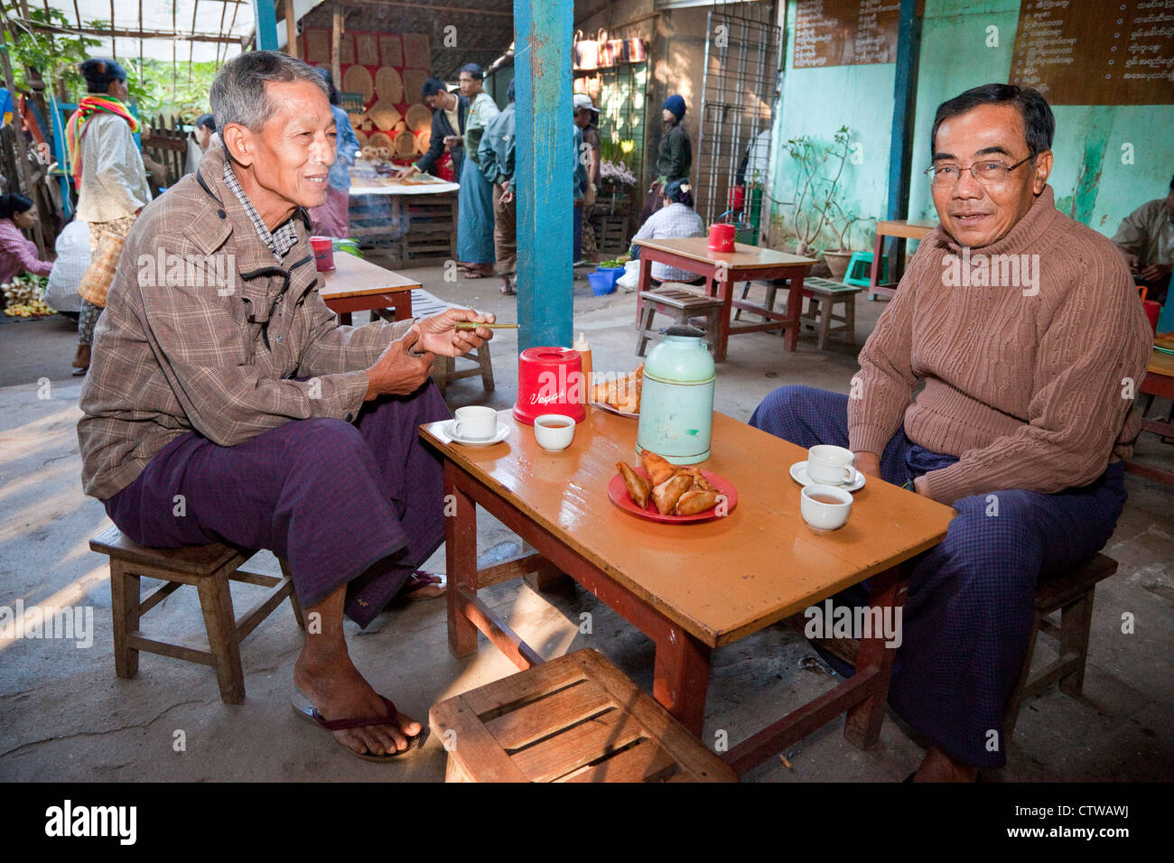 Myanmar, Burma. Two Men Enjoying Breakfast Tea. Bagan Market Cafe Stock ...