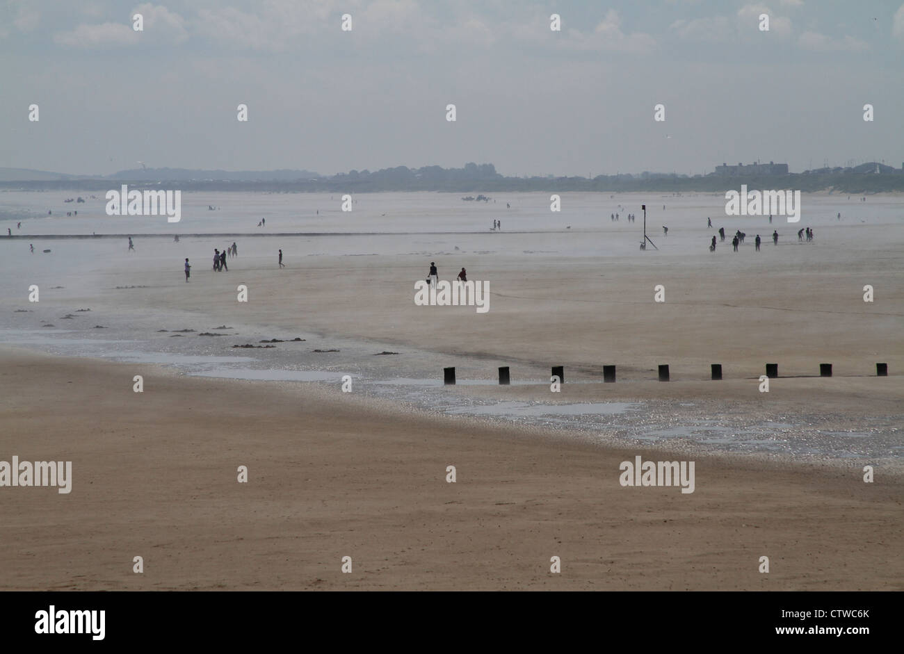 Mist on beach with people Stock Photo - Alamy