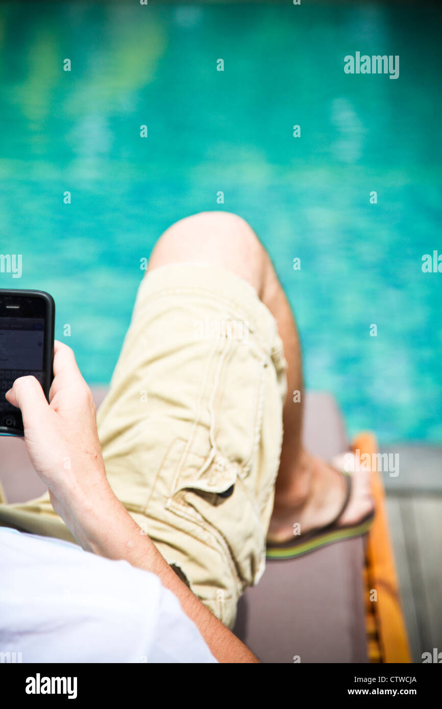 checking work emails on phone on holiday Stock Photo - Alamy