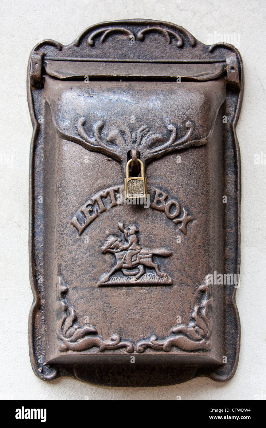 Old rusty mailbox in white wall Stock Photo - Alamy