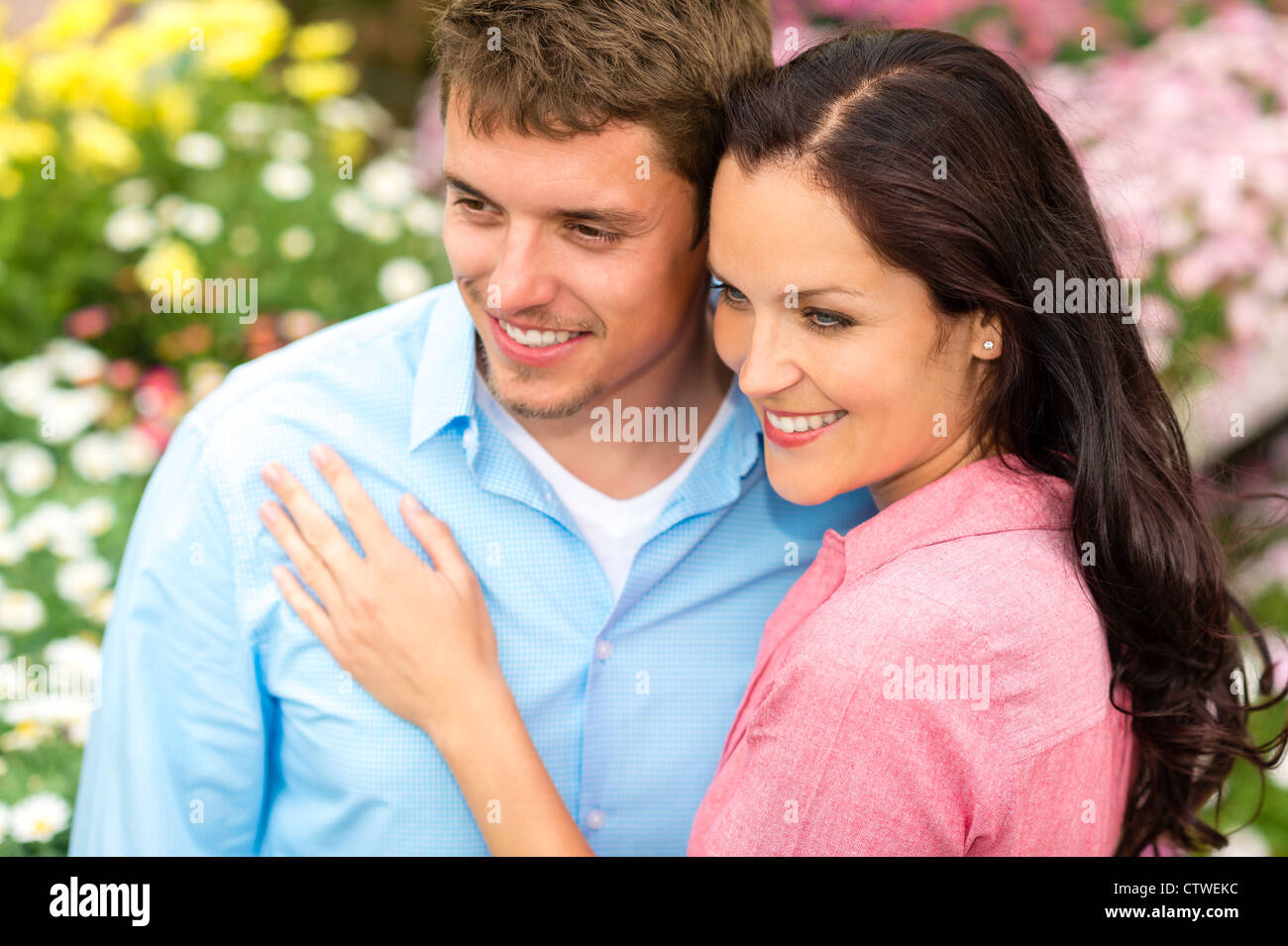 Happy young couple in love hugging in nature garden Stock Photo - Alamy