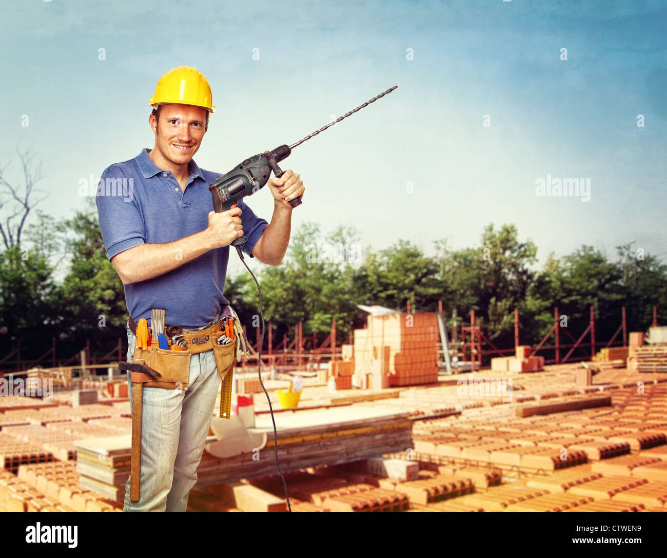 handyman with drill in construction site Stock Photo - Alamy