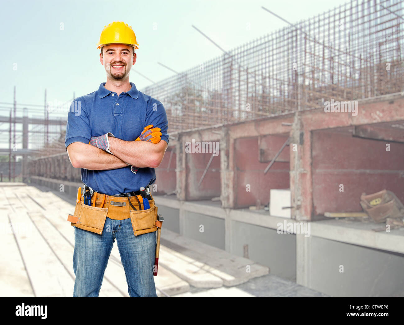 smiling man crossed arms at work in construction site Stock Photo - Alamy