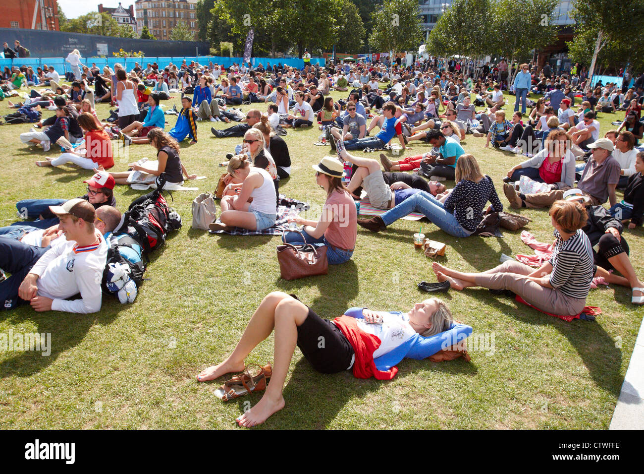 Spectators watch a large outdoor screen showing London 2012 Olympic ...