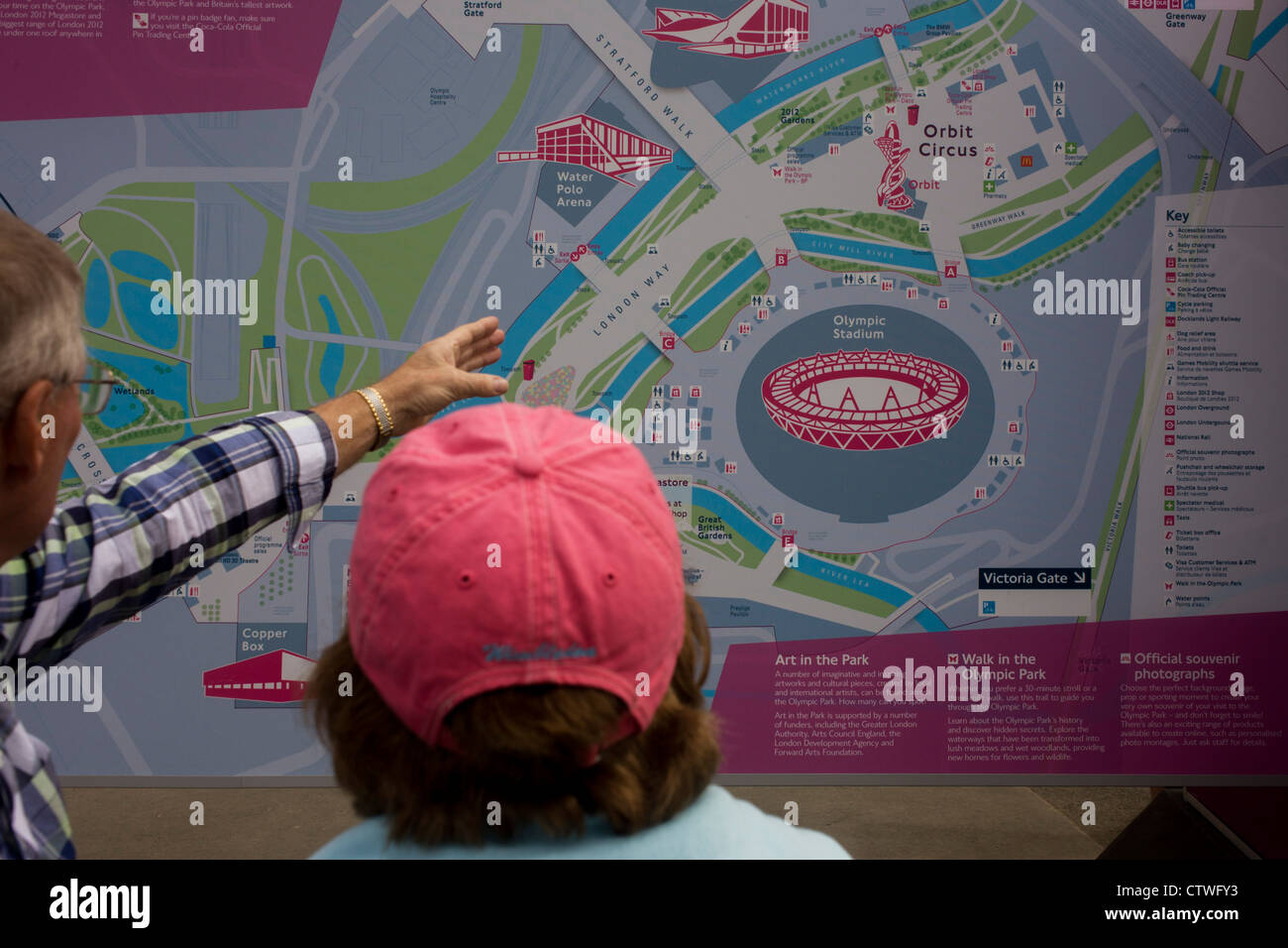 Spectators consult a detailed map of the Olympic Park during the London ...