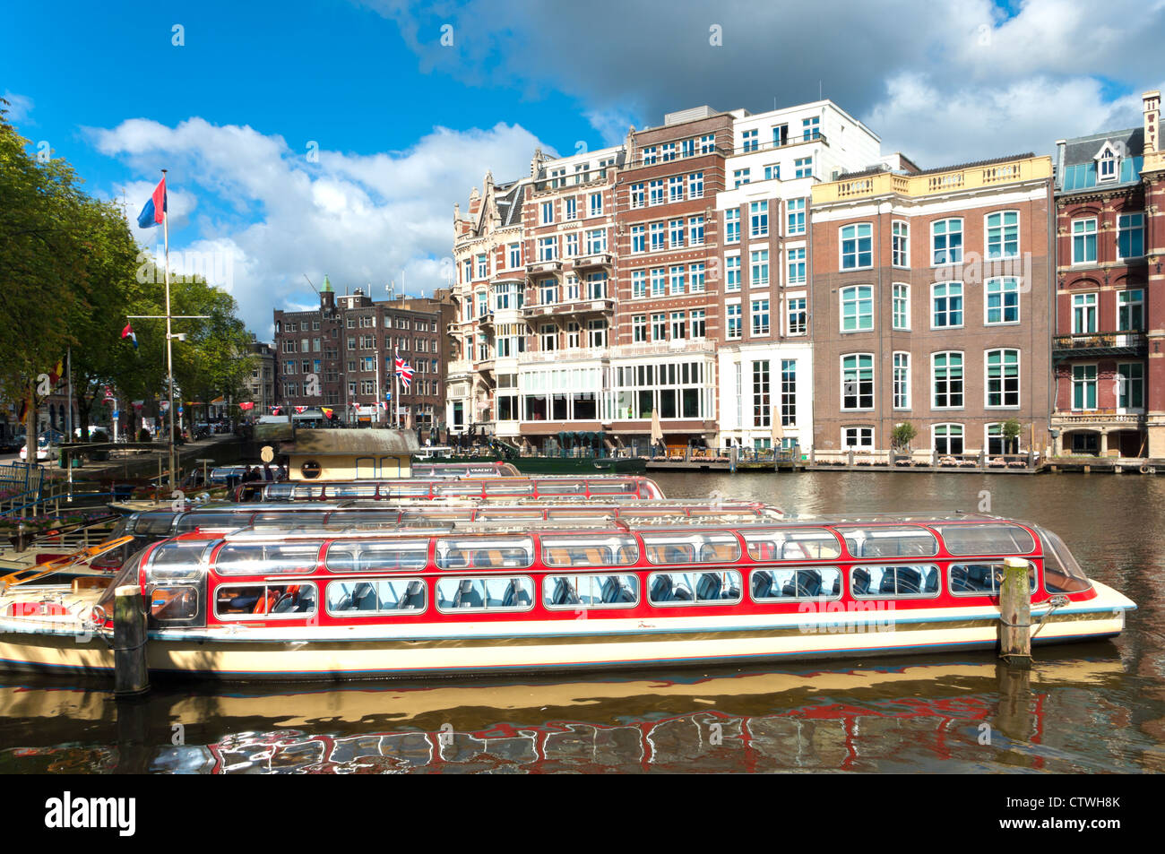 sightseeing boats in typical amsterdam canal Stock Photo - Alamy