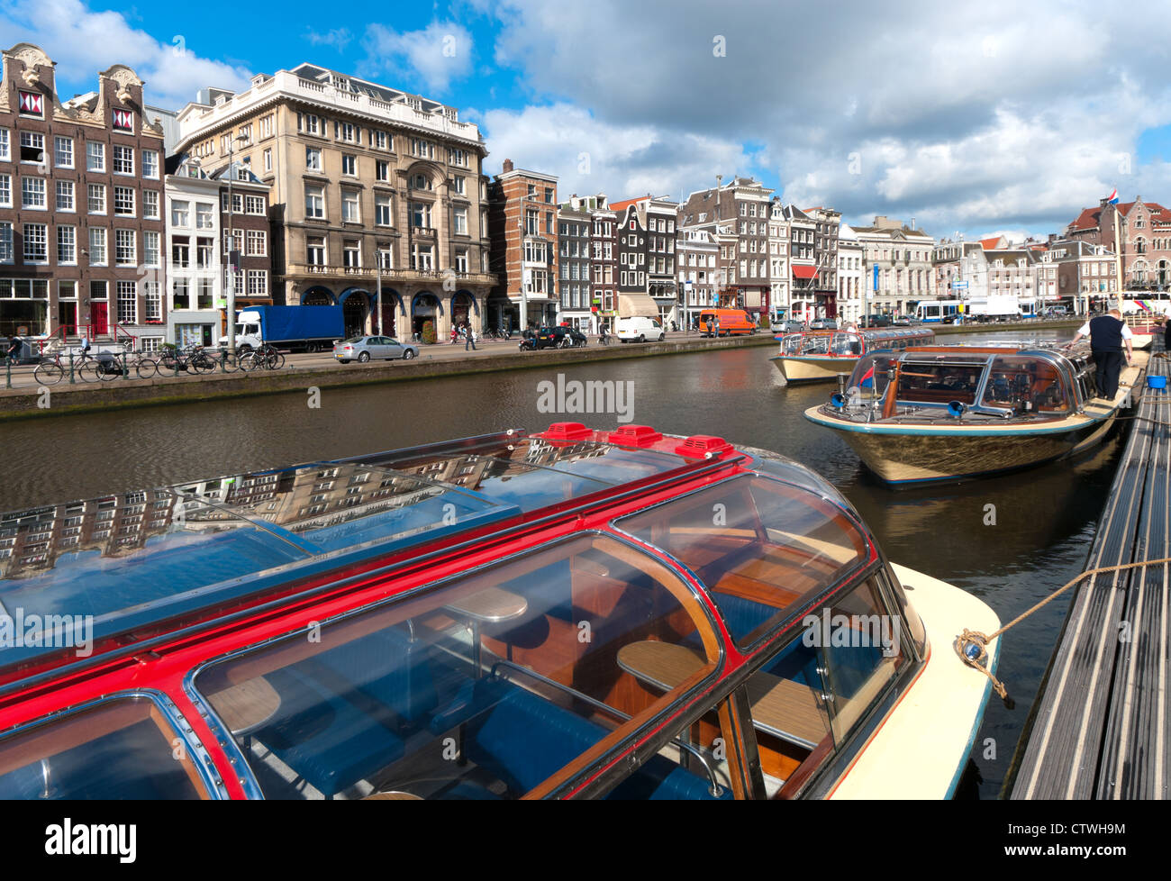 sightseeing boats in typical amsterdam canal Stock Photo - Alamy