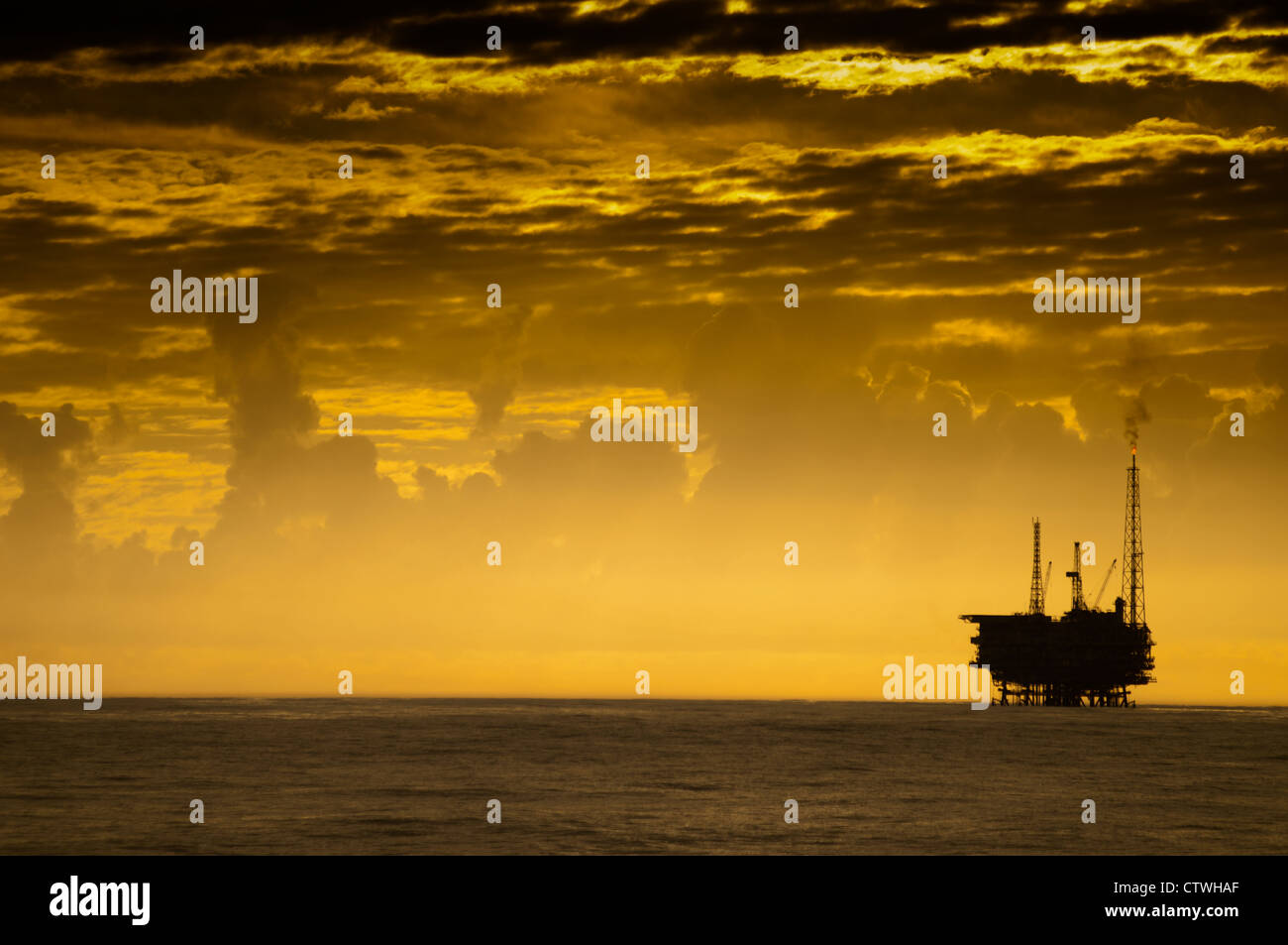 Silhouette of an oil drilling rig offshore in sunset/sunrise time Stock ...