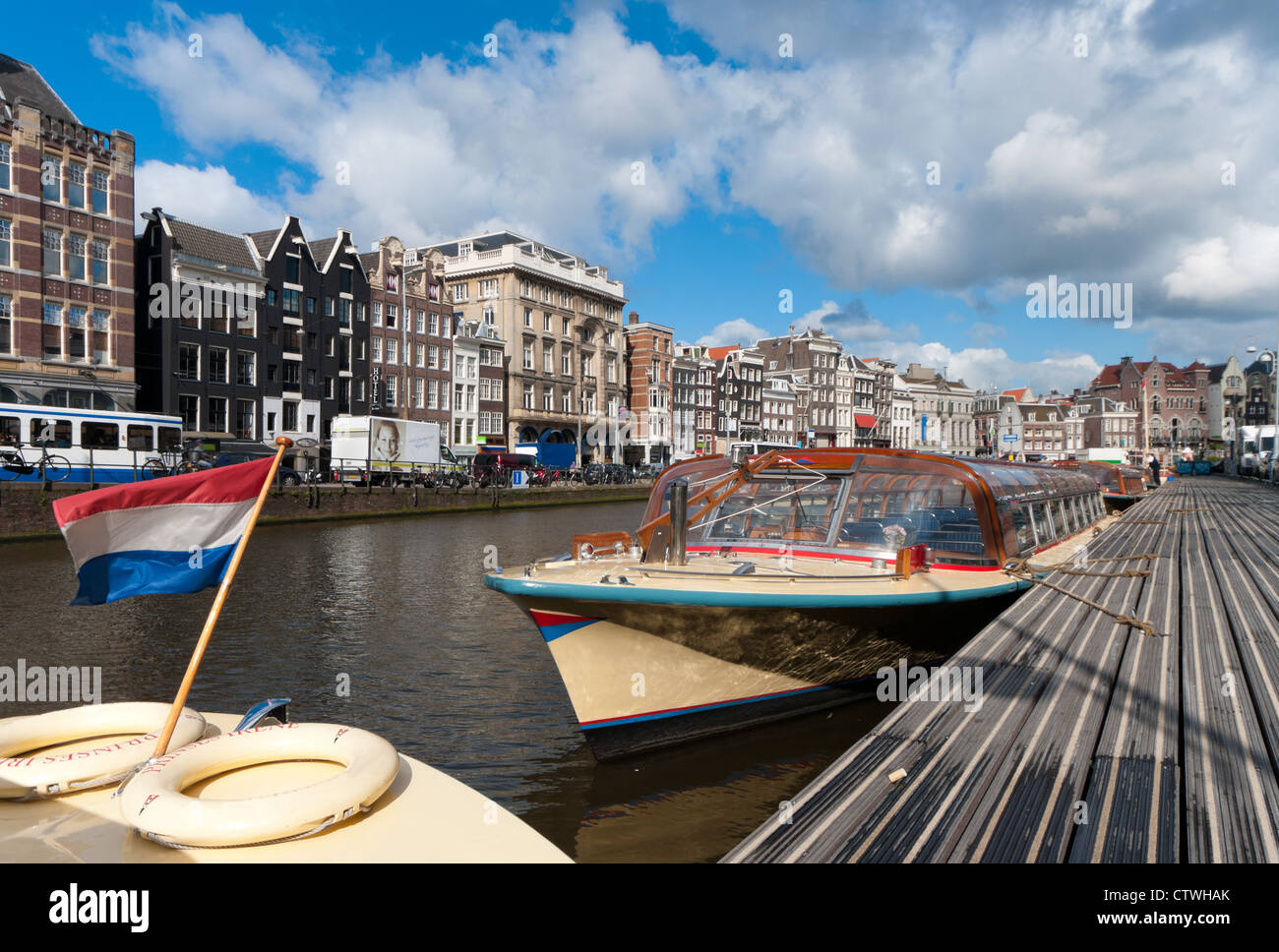 sightseeing boats in typical amsterdam canal Stock Photo - Alamy