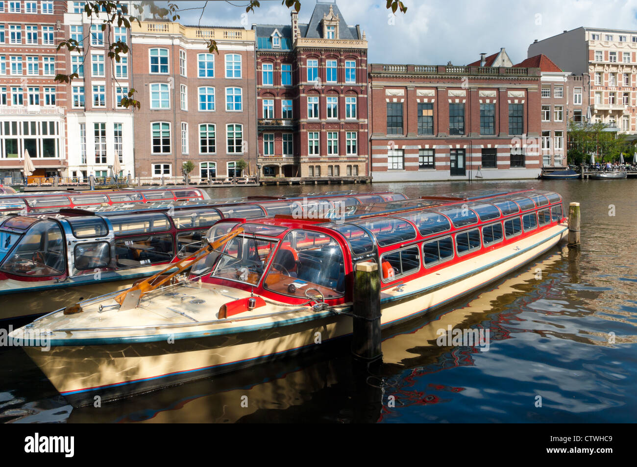 sightseeing boats in typical amsterdam canal Stock Photo - Alamy