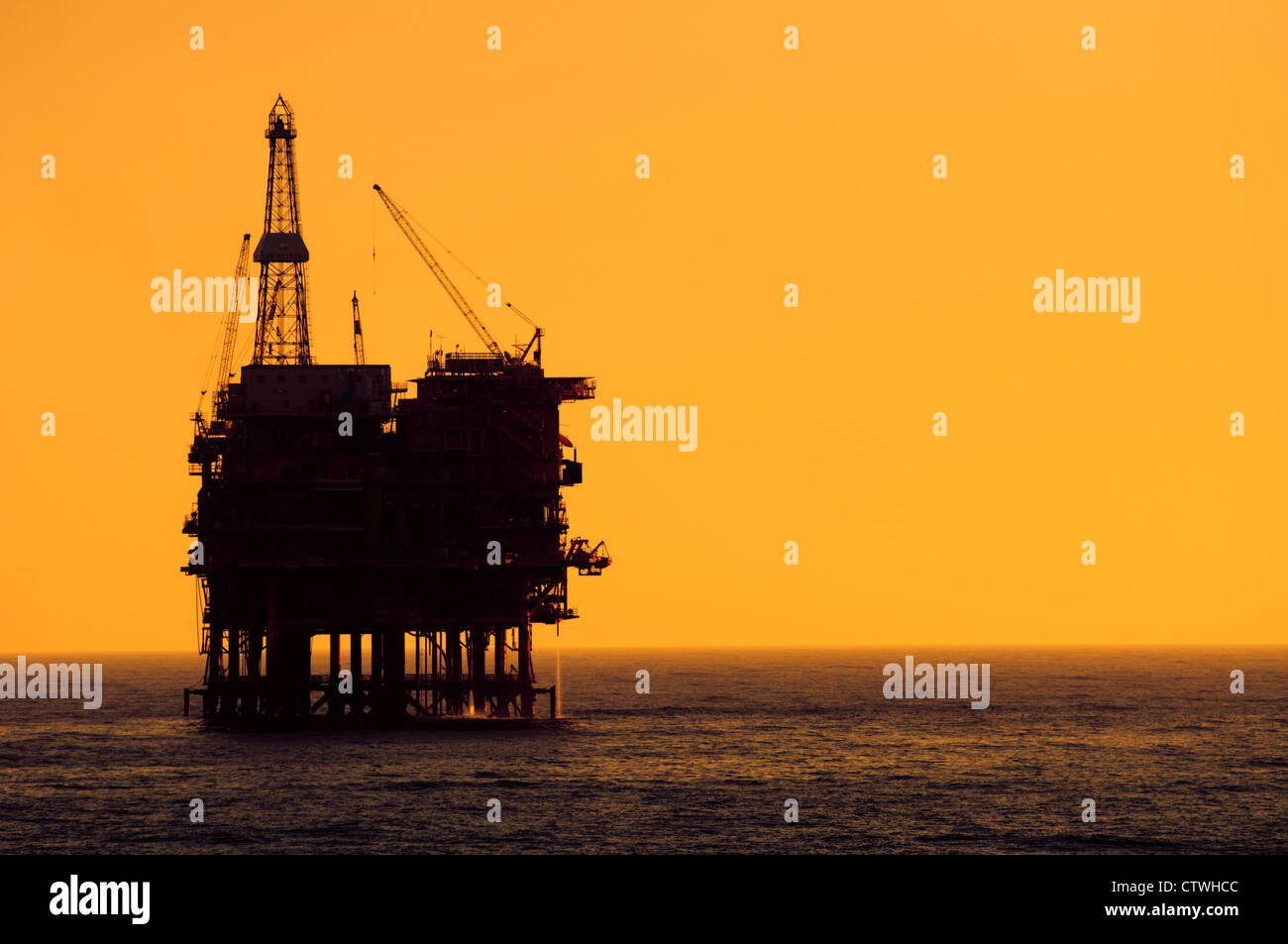 Silhouette of an oil drilling rig offshore in sunset/sunrise time Stock ...