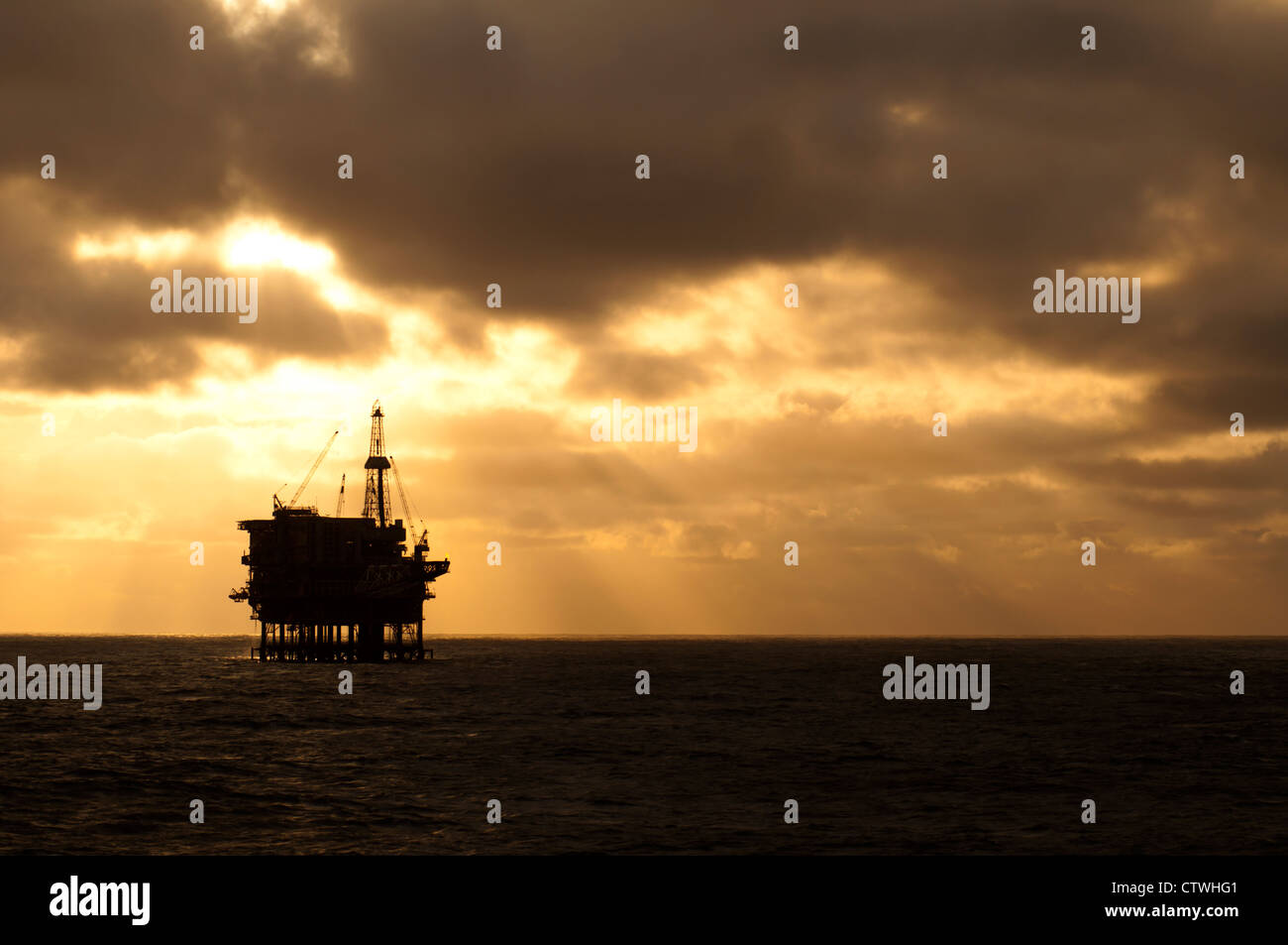Silhouette of an oil drilling rig offshore in sunset/sunrise time Stock ...
