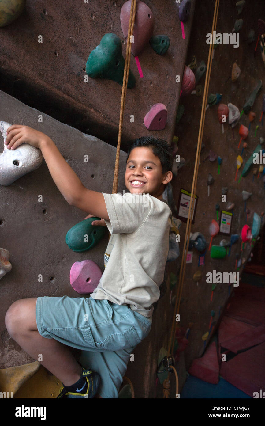 Kid climb rock wall indoor hispanic hi-res stock photography and images ...