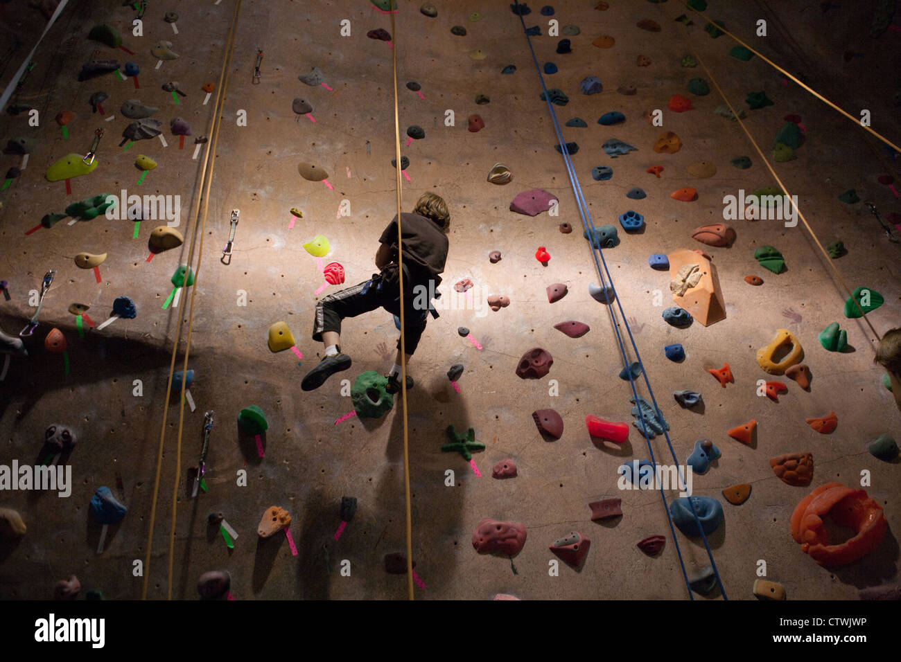 Boy coming down from a climbing wall Stock Photo - Alamy