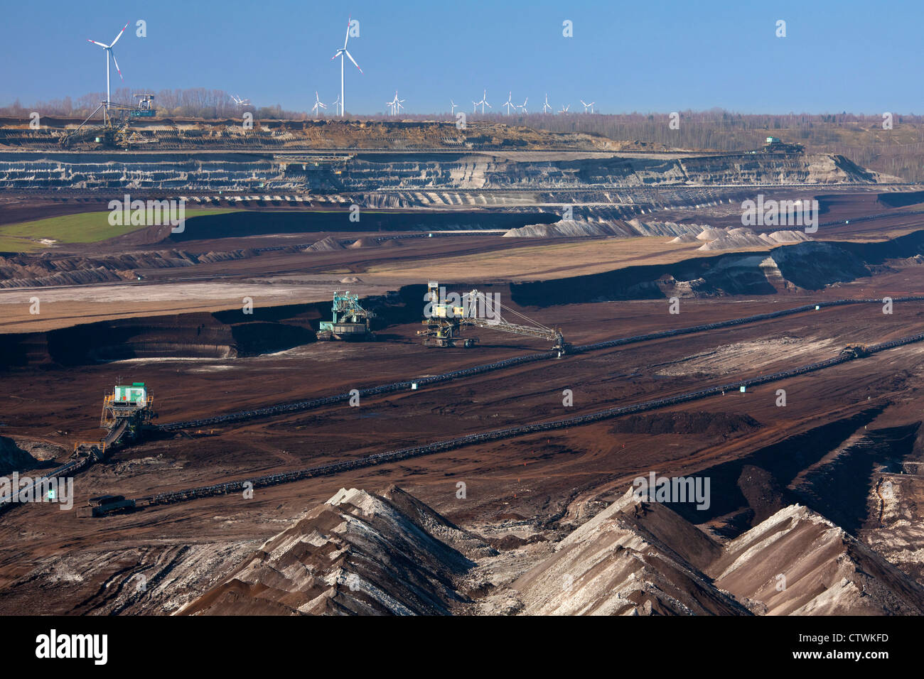 Spoil heaps and brown coal / lignite being extracted by huge bucket ...