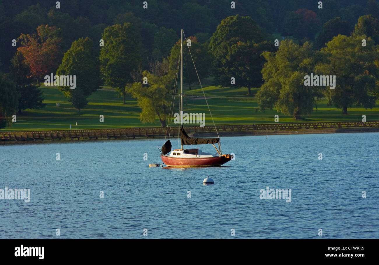 SAILBOAT ANCHORED IN WATER Stock Photo - Alamy
