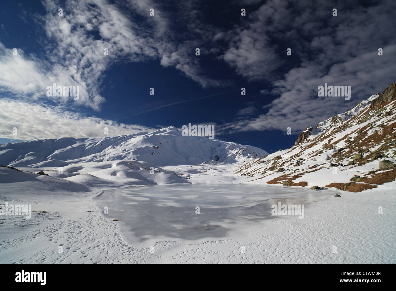 Frozen lake in Greina plains in Switzerland Stock Photo - Alamy