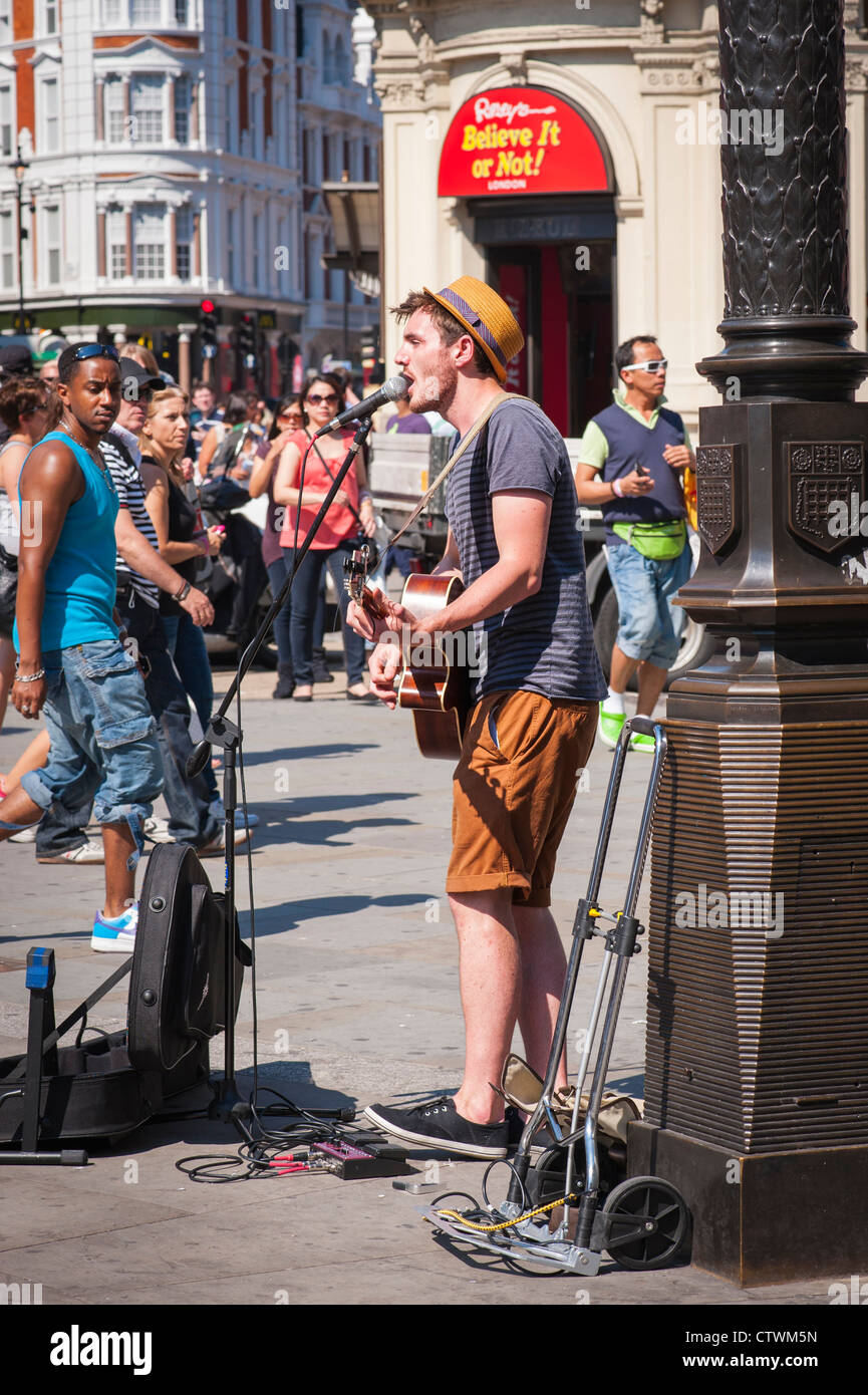 London Piccadilly Circus busker young man boy lad male guitar ...