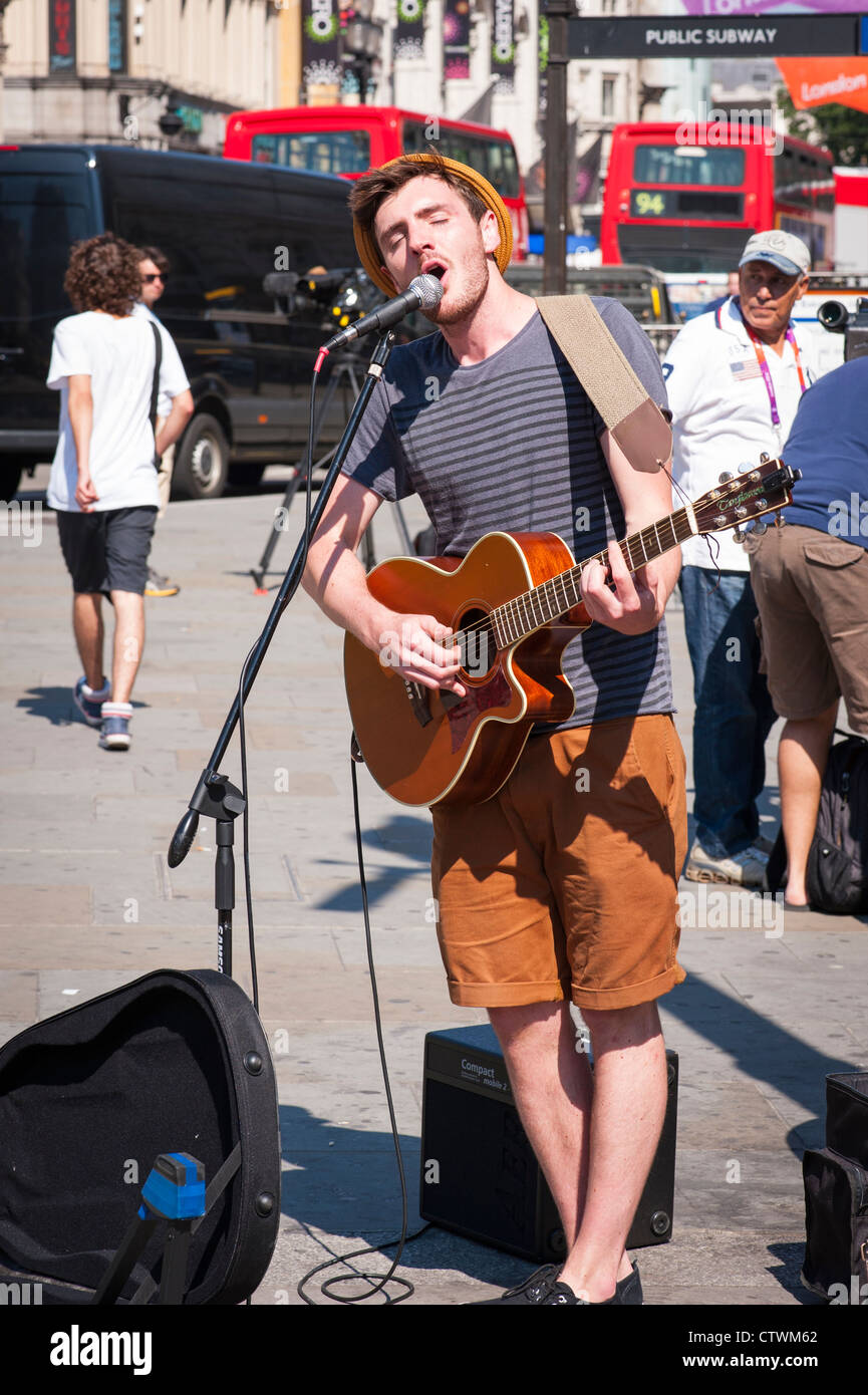 London Piccadilly Circus busker young man boy lad male guitar ...