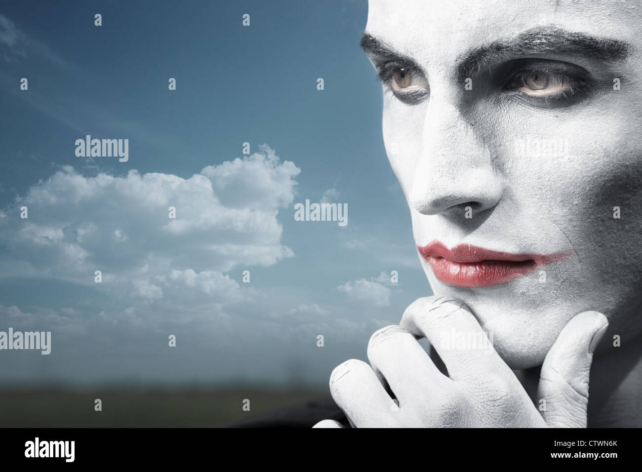 Pensive clown outdoors with theatrical makeup. Horizontal photo ...