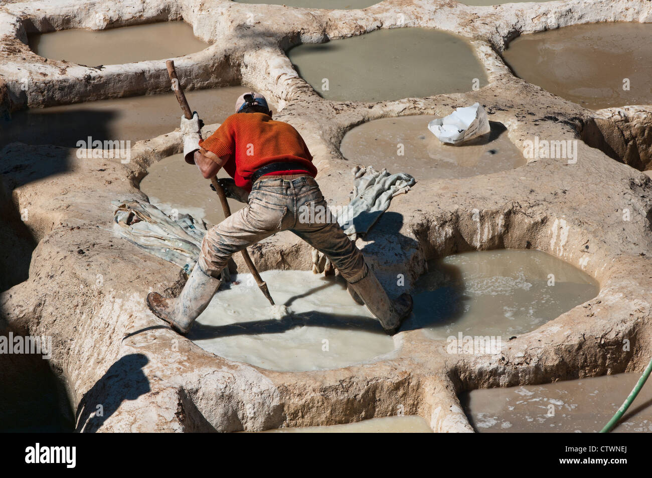 worker in the thousand year old leather tannery in the ancient medina ...