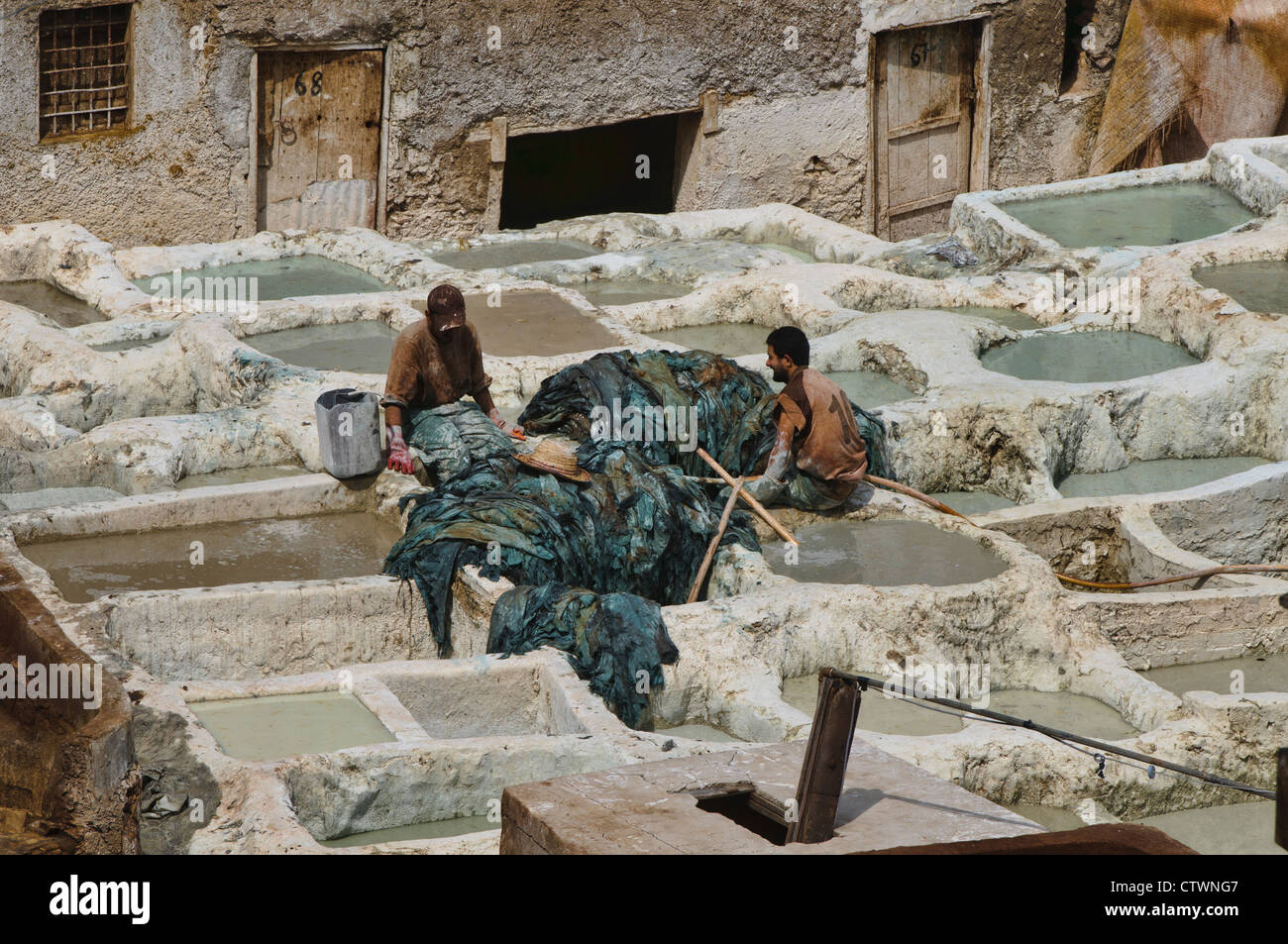 workers in the thousand year old leather tannery in the ancient medina ...