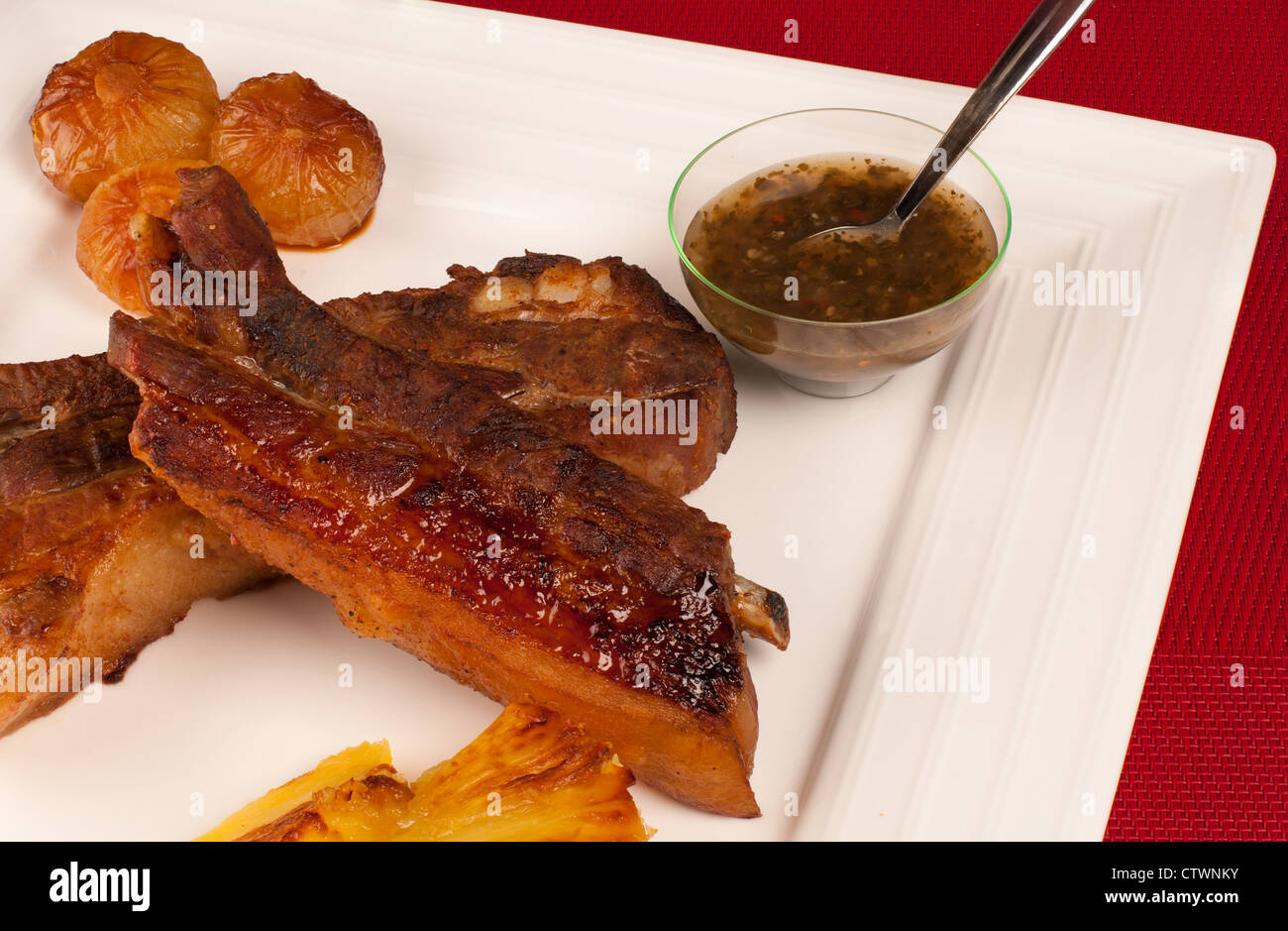 Grilled caramelized pork ribs served with garnish and Argentinian ...