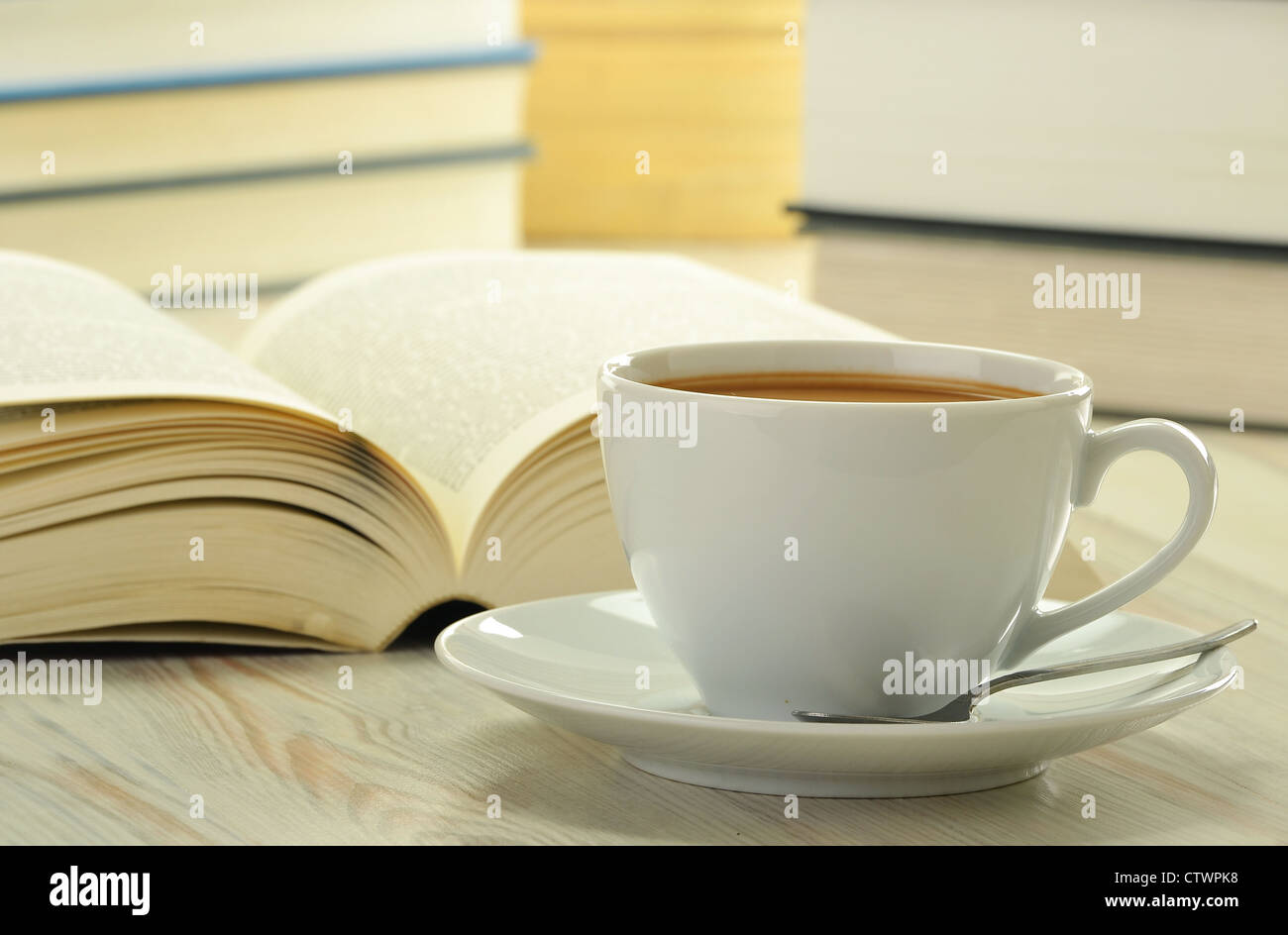 Composition with books and cup of coffee on the table Stock Photo - Alamy