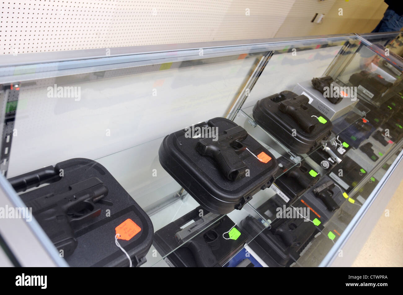 A glass case houses guns for sale at Second Amendment Sports, Tucson ...