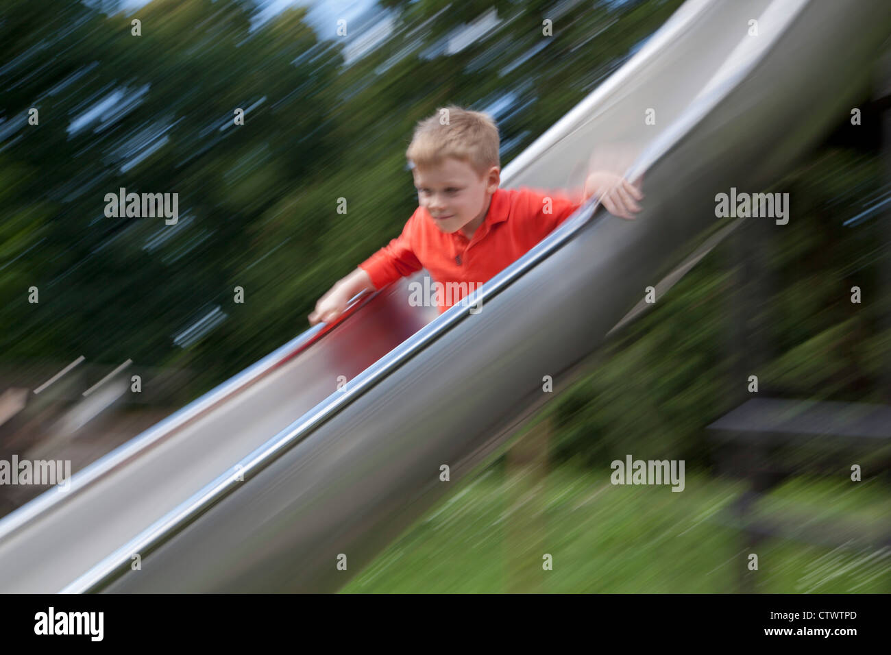 young boy on a slide Stock Photo - Alamy